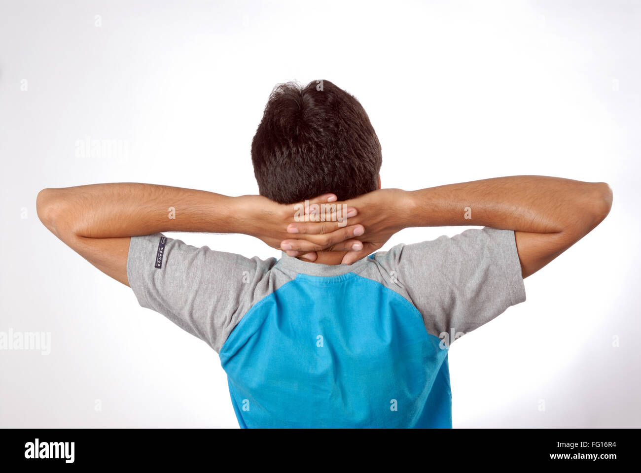 South Asian Indian man doing exercise keeping both hand back side of ...