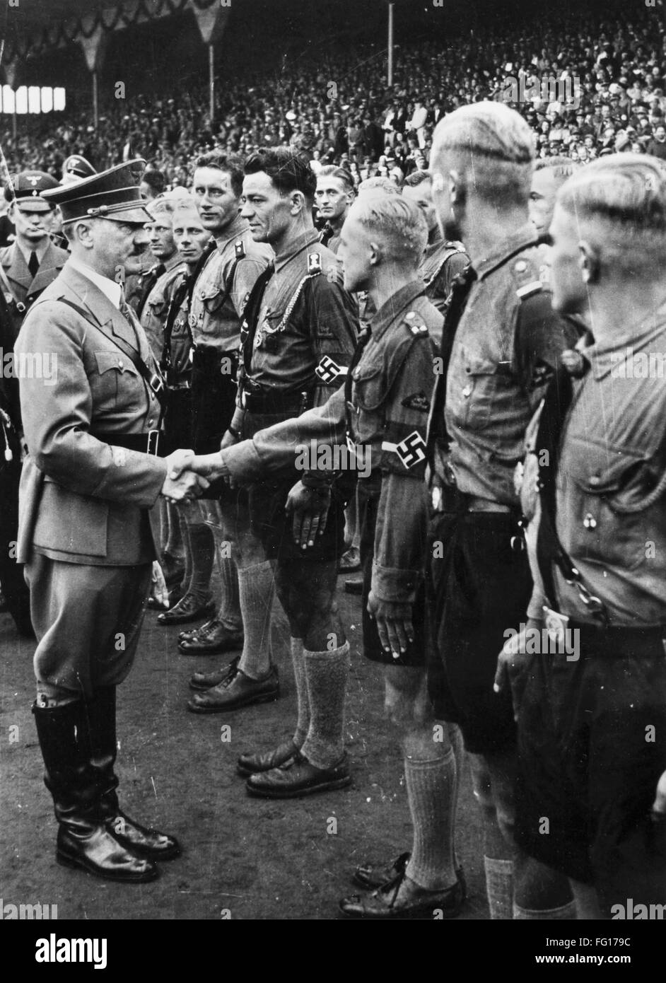 HITLER YOUTH, 1937. /nAdolf Hitler shaking hands with Hitler Youth at a ...
