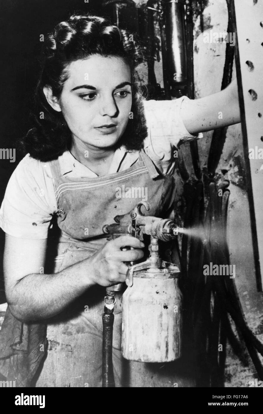 WWII: WORKER, 1942. /nA woman spraying paint on electrical control ...