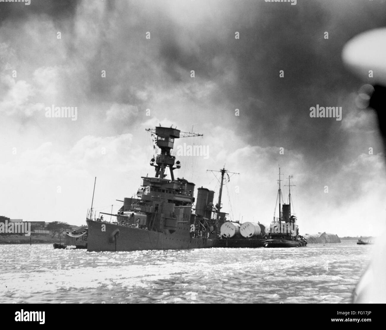 WWII: USS RALEIGH, 1941. /nThe USS Raleigh being kept afloat by barges ...