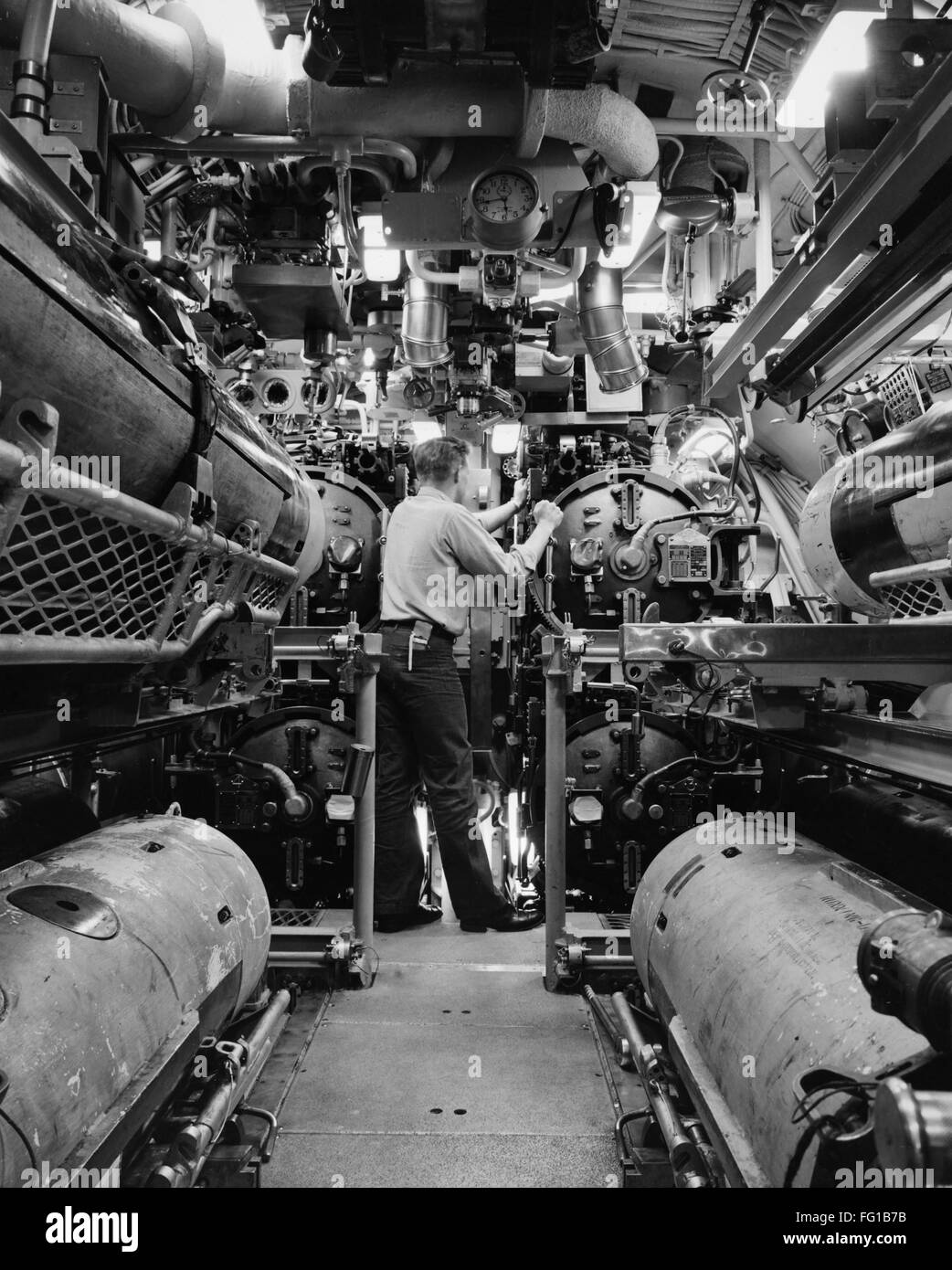NAVY: USS NAUTILUS, 1958. /nA torpedoeman checking the torpedo tubes of ...