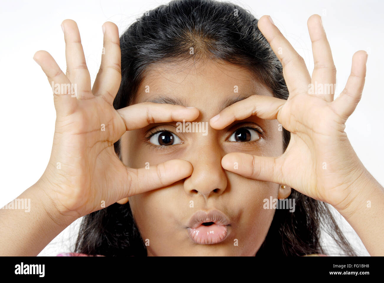 Young girl looking through fingers MR# 152 Stock Photo - Alamy