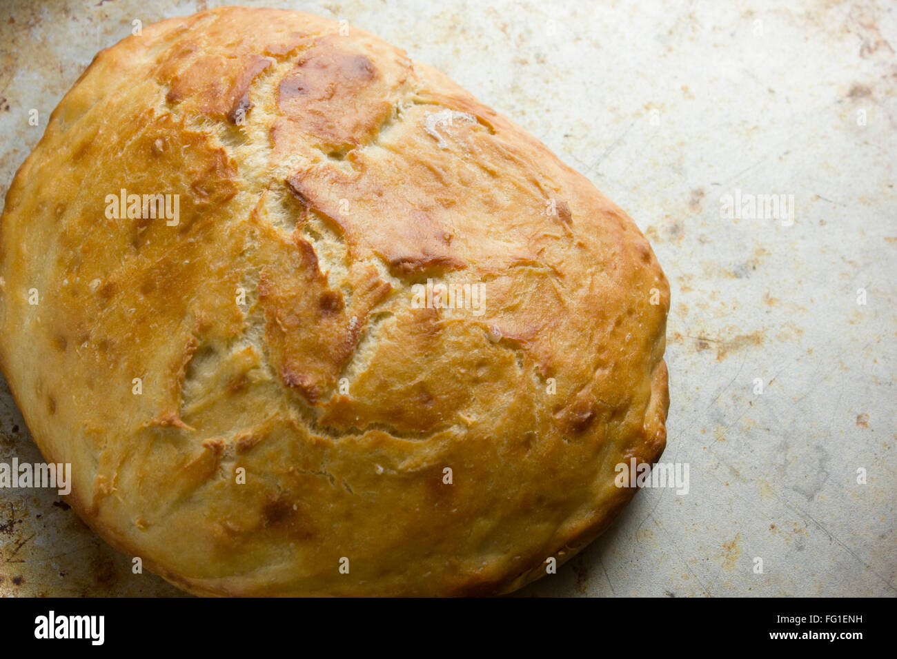 A round, golden brown loaf of homemade artisan bread Stock Photo - Alamy