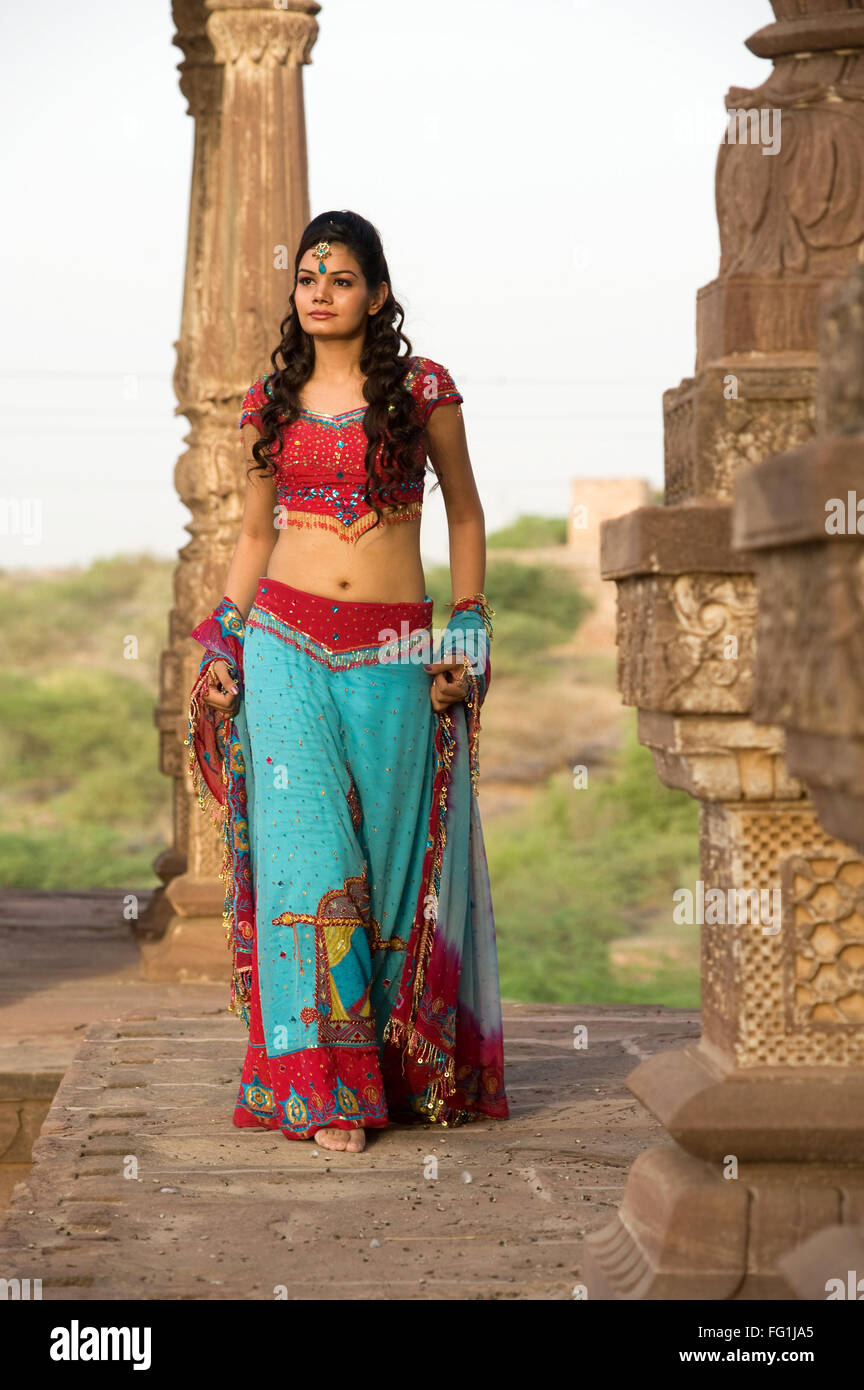 Lady in traditional wearing walking at heritage structure ; India MR ...