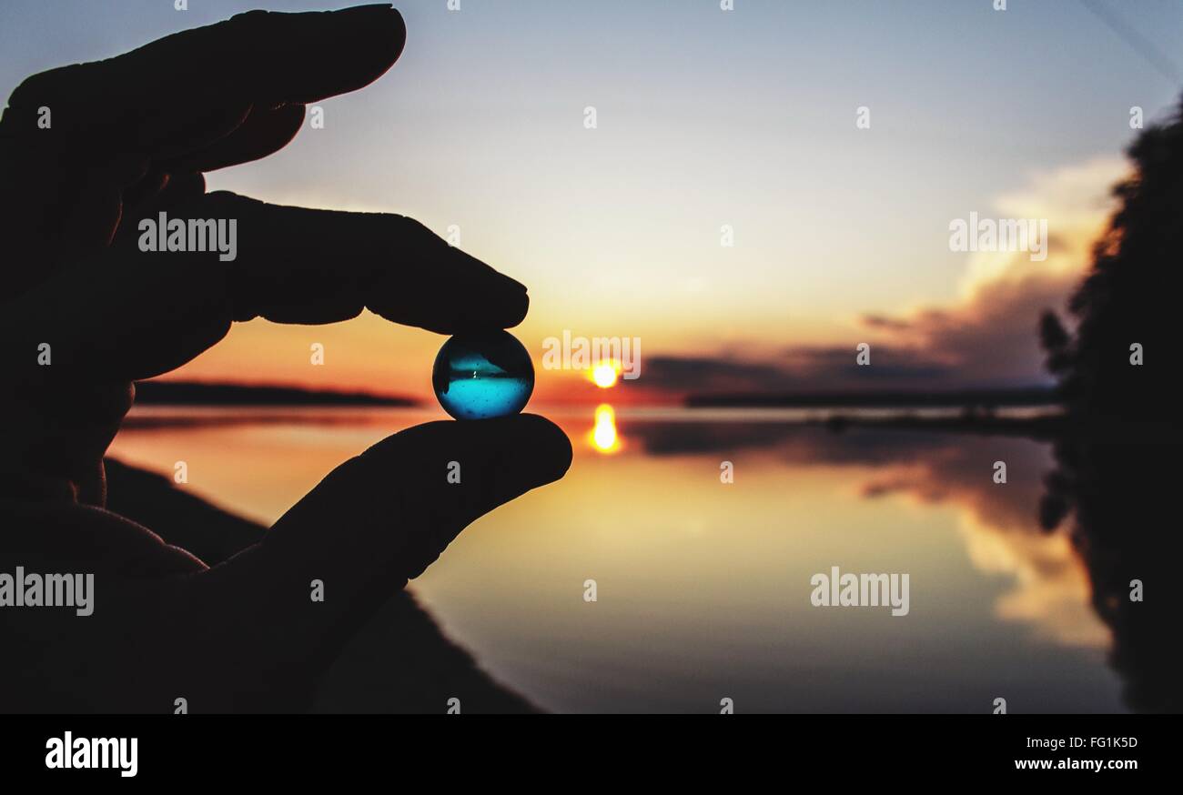 Hand holding glass marble hi-res stock photography and images - Alamy