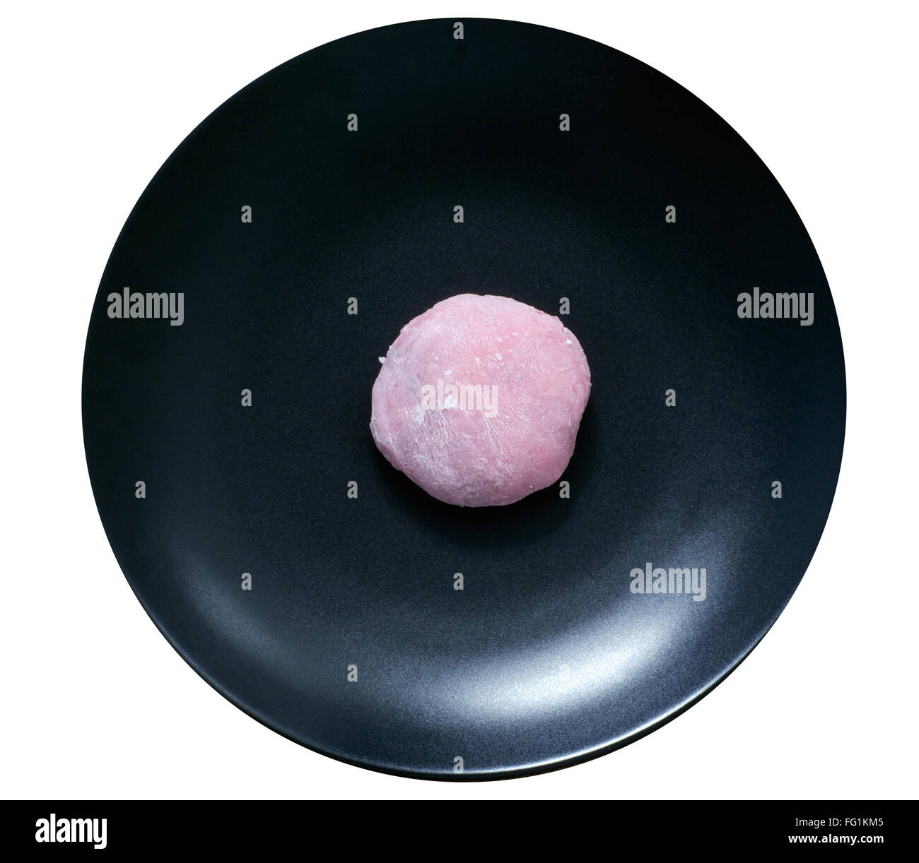 Isolated pink mochi japanese sweet rice treat with filling on the black ...