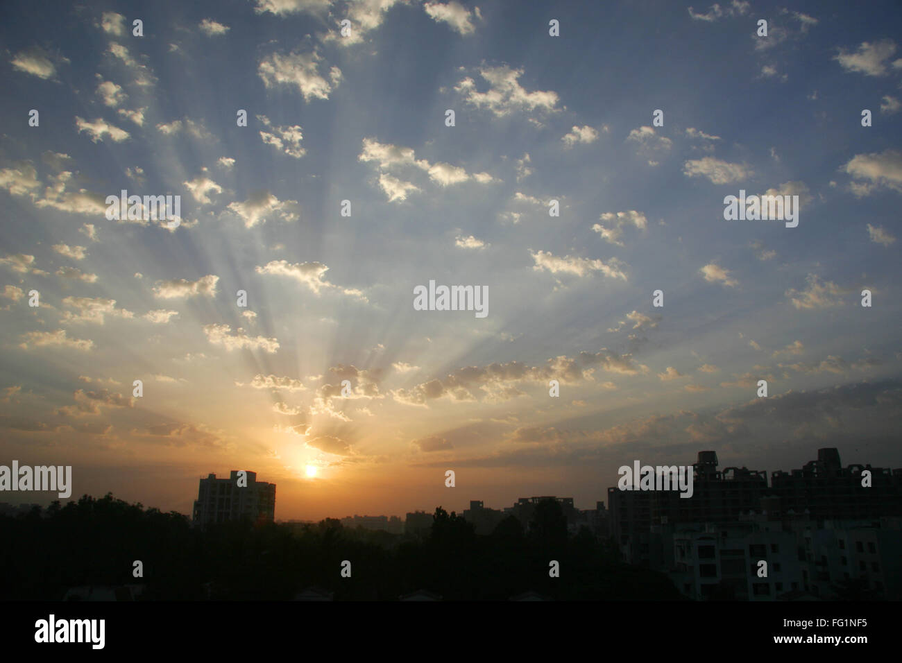 Glorious sunrise with white fluffy clouds and blue skies , Pune ...
