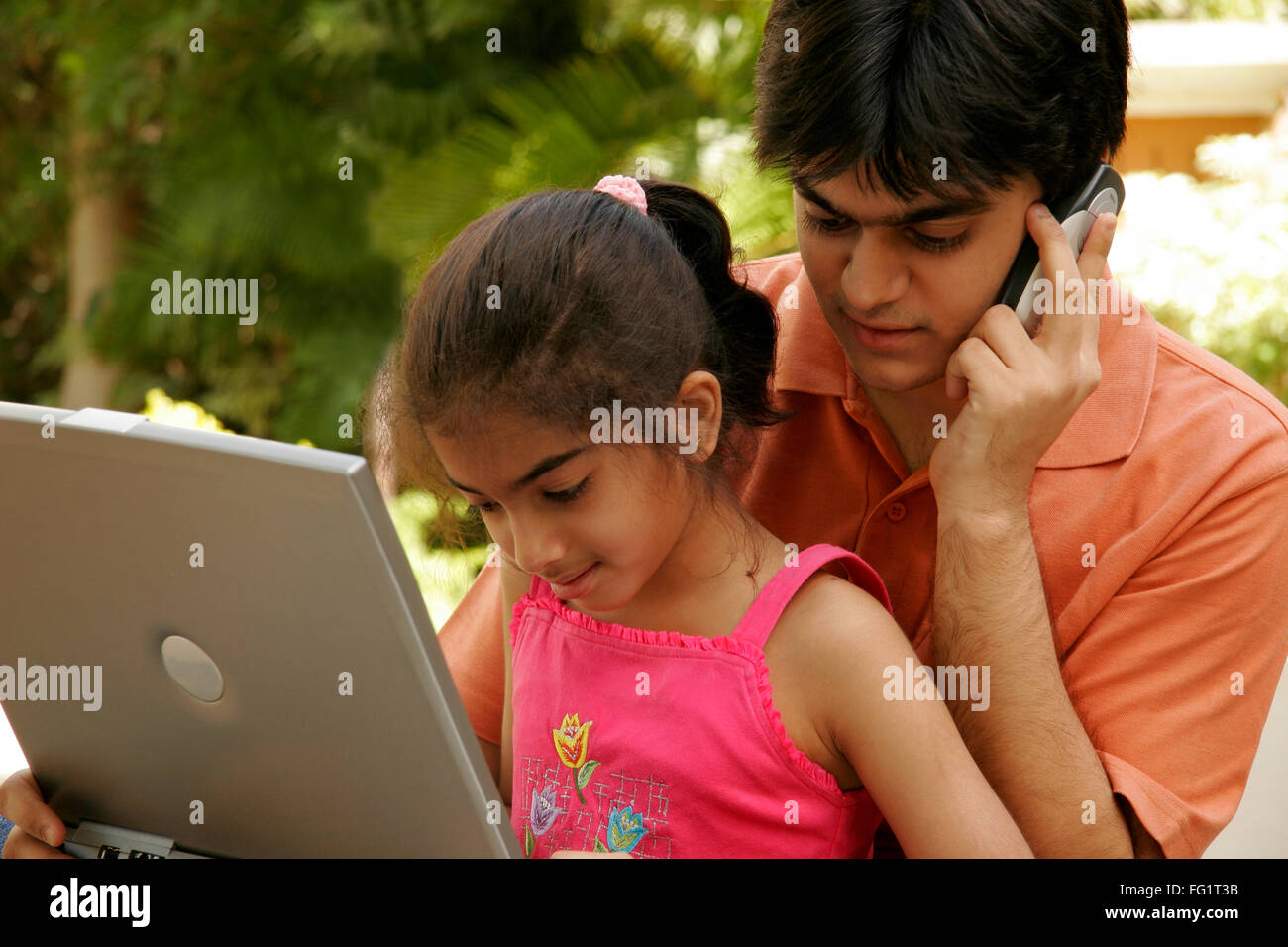 Indian girl teaching brother hi-res stock photography and images - Alamy