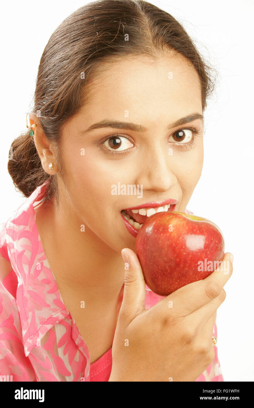 South Asian Indian Teenage Girl Eating Red Apple As Healthy Fruit Mr