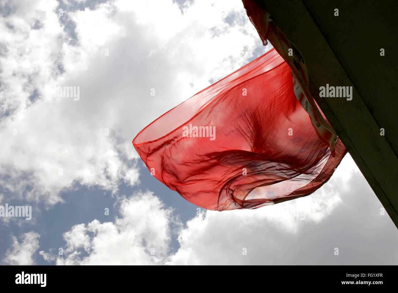 Indian traditional ladies wear saris flying in air against white clouds ...