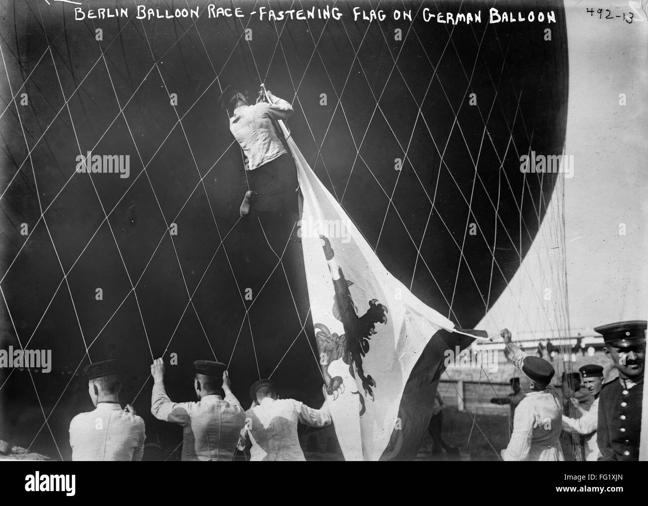 BERLIN: BALLOON RACE, 1908. /nA man attaching a German flag to a hot ...
