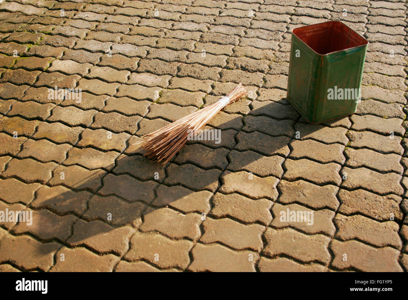 Sweeping device jhadu and tin box to put garbage against cleaned floor ...