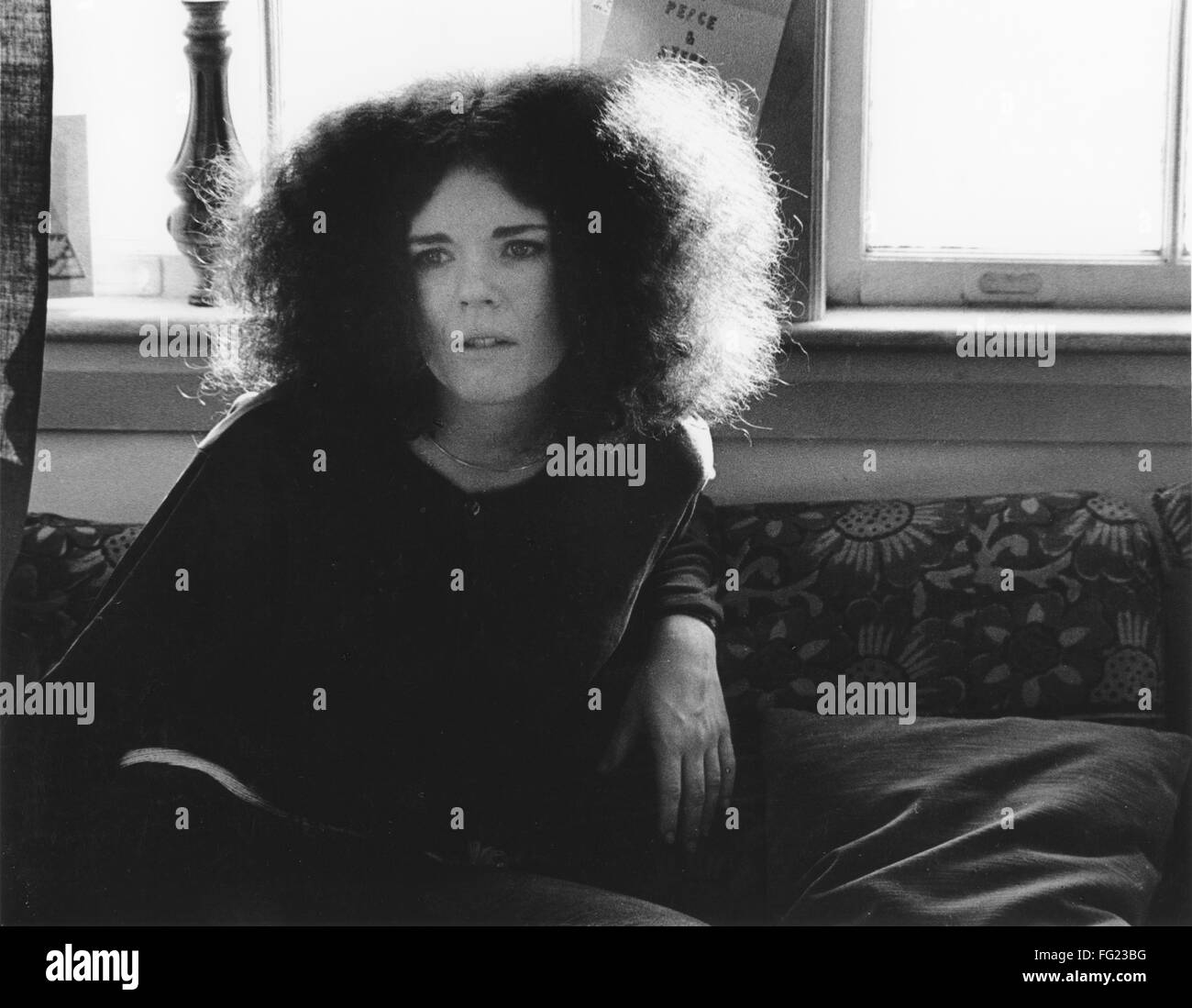 HIPPIE MOVEMENT, 1971. /nA hippie woman with large hair relaxes on a ...