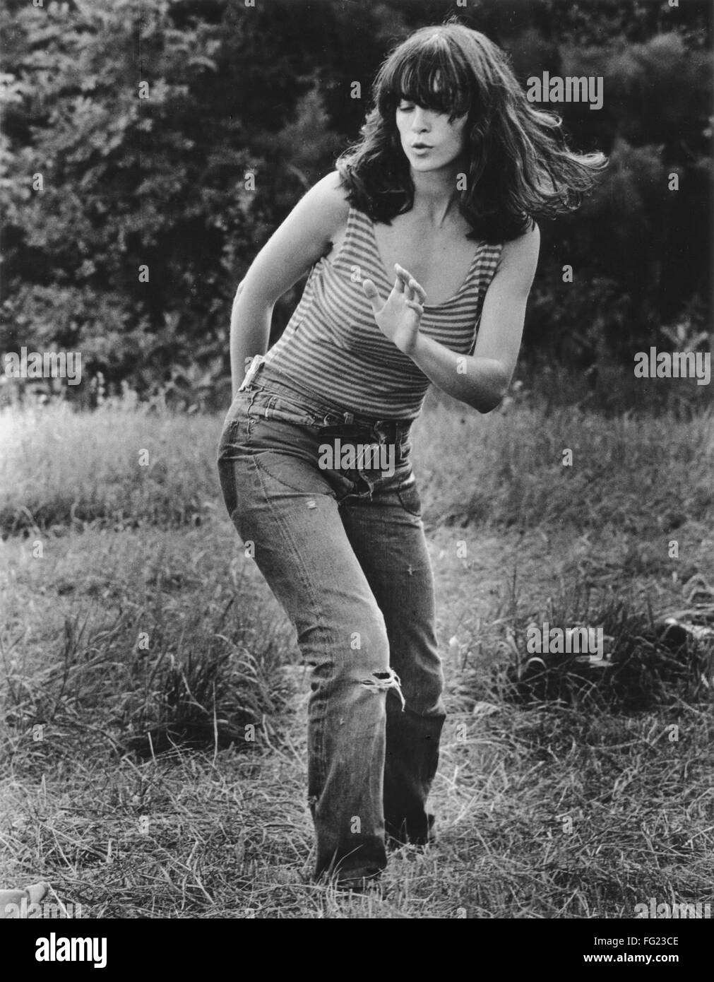 HIPPIE MOVEMENT, 1970. /nA hippie woman dances by herself in a field at ...