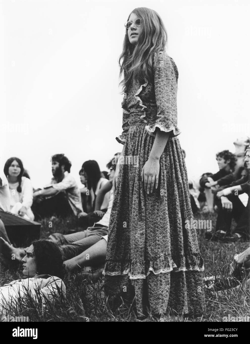 HIPPIE MOVEMENT, 1970. /nA young hippie woman listens to music at an ...