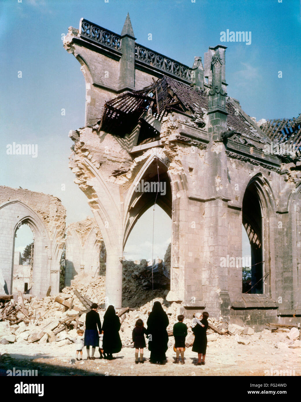 WWII: VALOGNES, 1944. /nTwo nuns and a French family stand before the ...