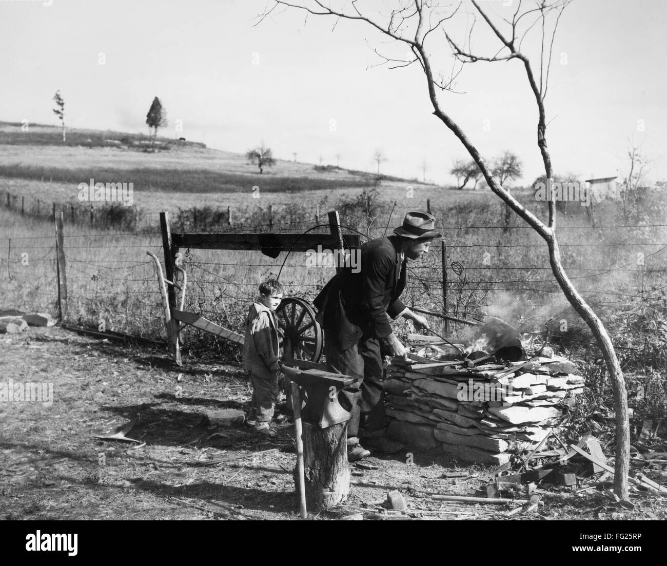 TENNESSEE: OUTDOOR FORGE. /nA man working at his outdoor forge in ...