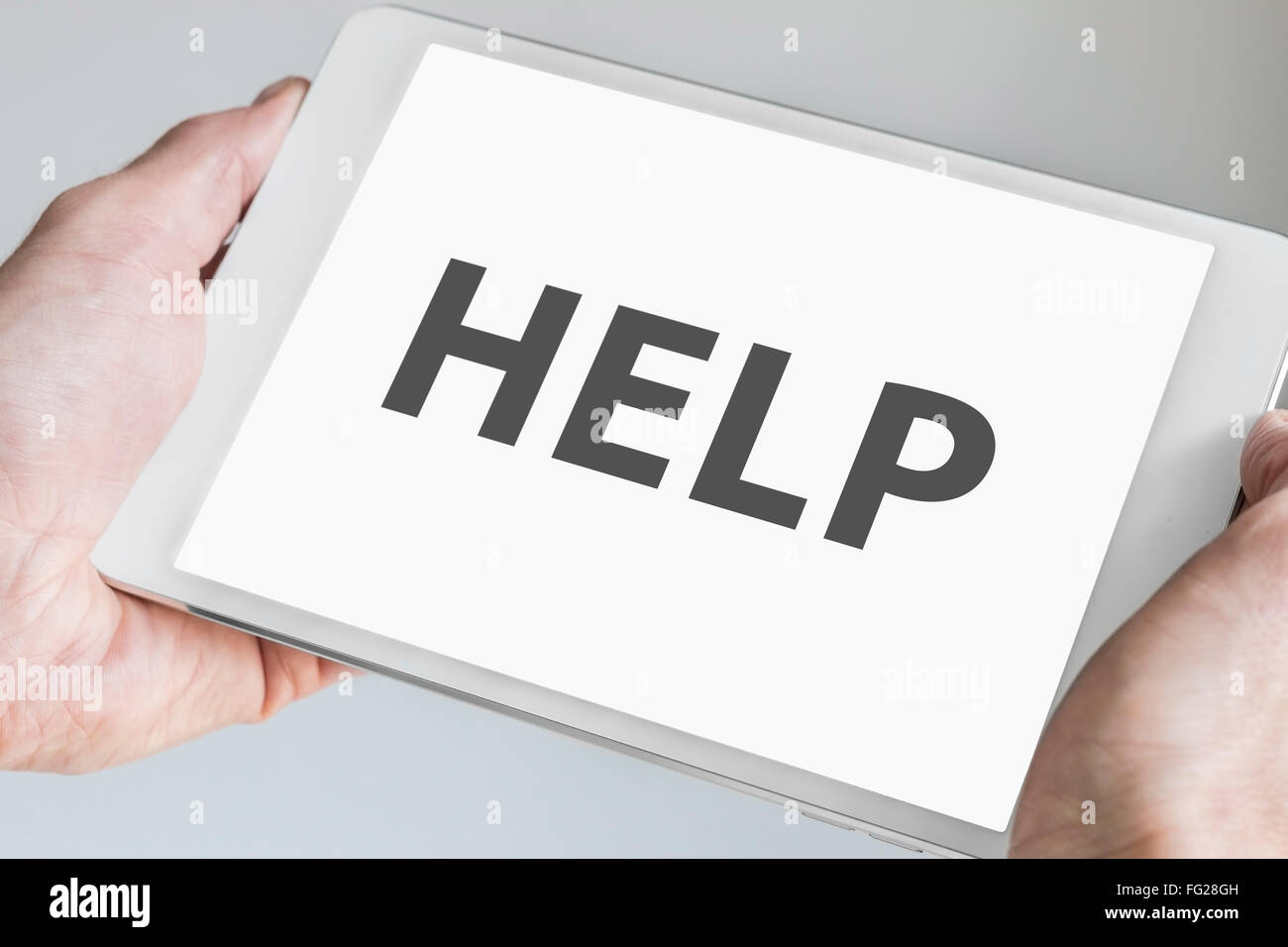 Help word displayed on touch screen of modern tablet computer. Hands ...