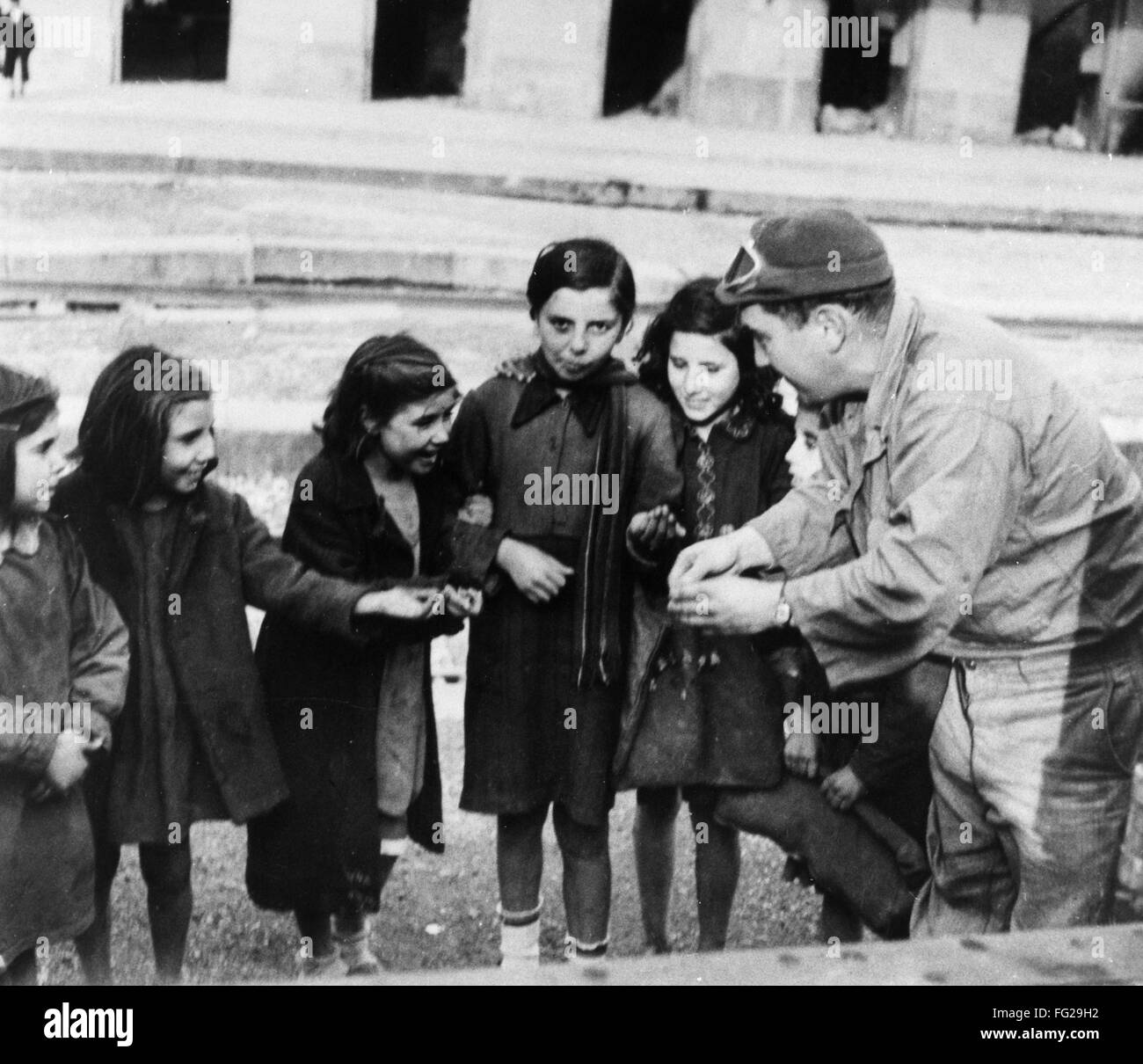 WWII: ITALY, 1944. /nAn American soldier giving candy to Italian ...
