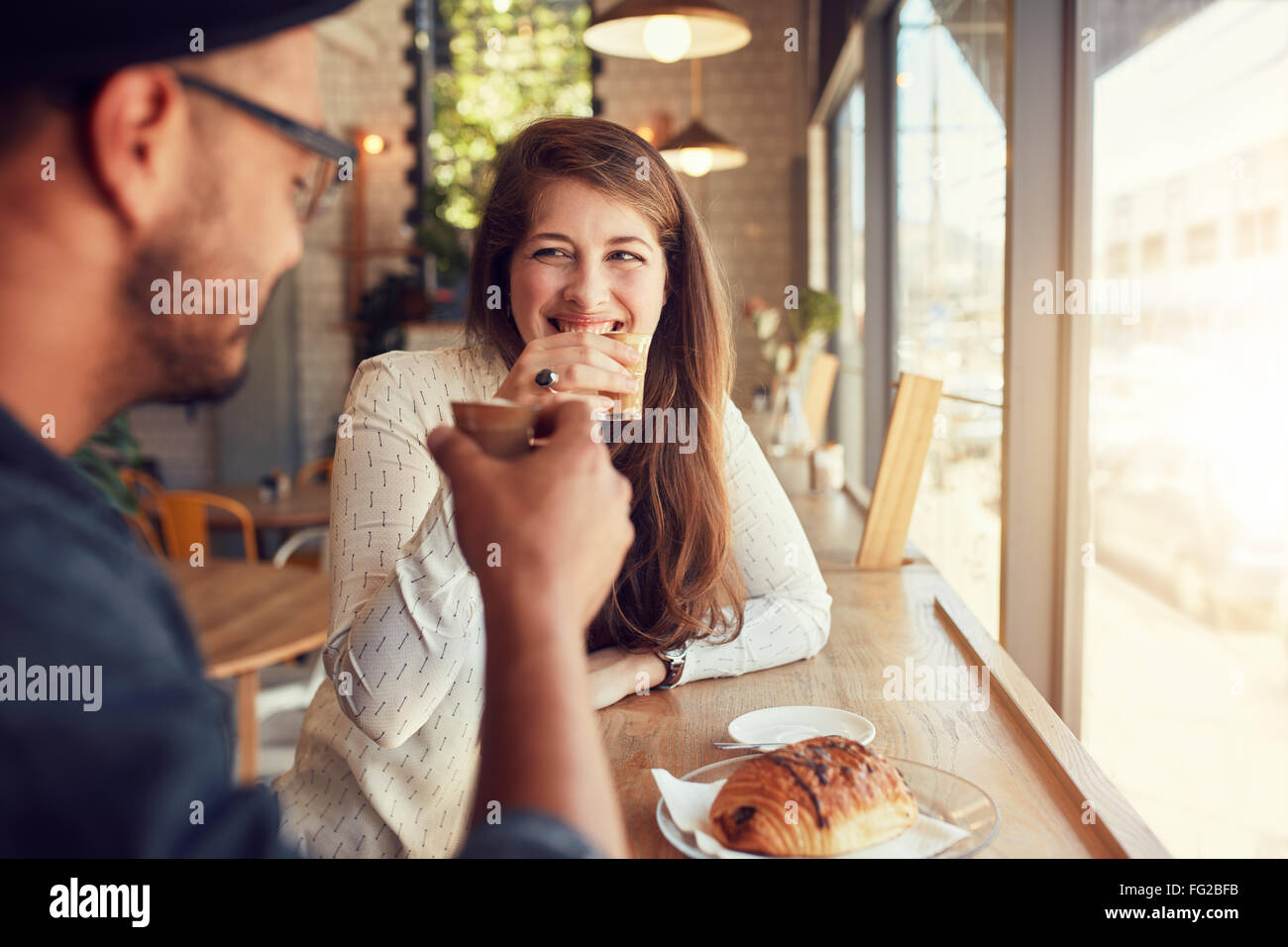Portrait of a casual young couple having coffee together at the coffee ...