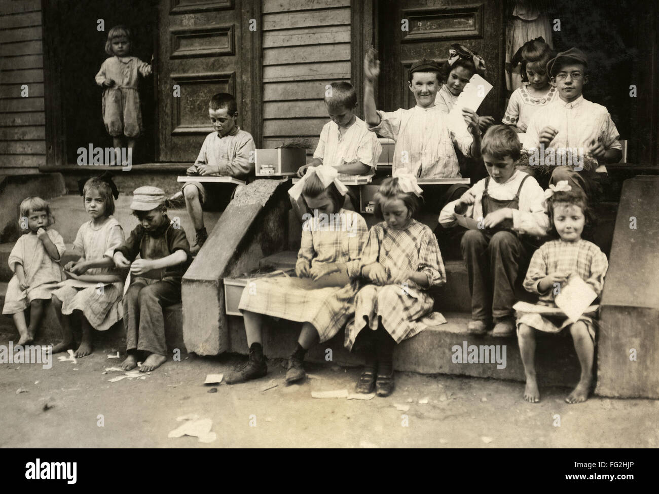 HINE: HOME INDUSTRY, 1912. /nBoys and girls working on garment tags on ...