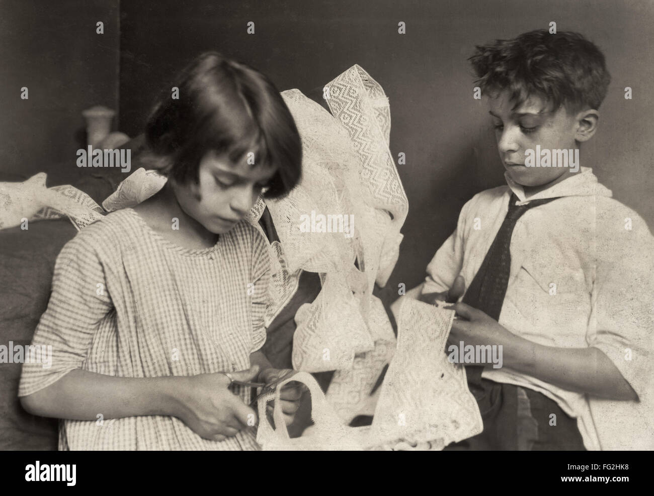 HINE: CHILD LABOR, 1924. /nA young girl and boy cutting lace at home in ...