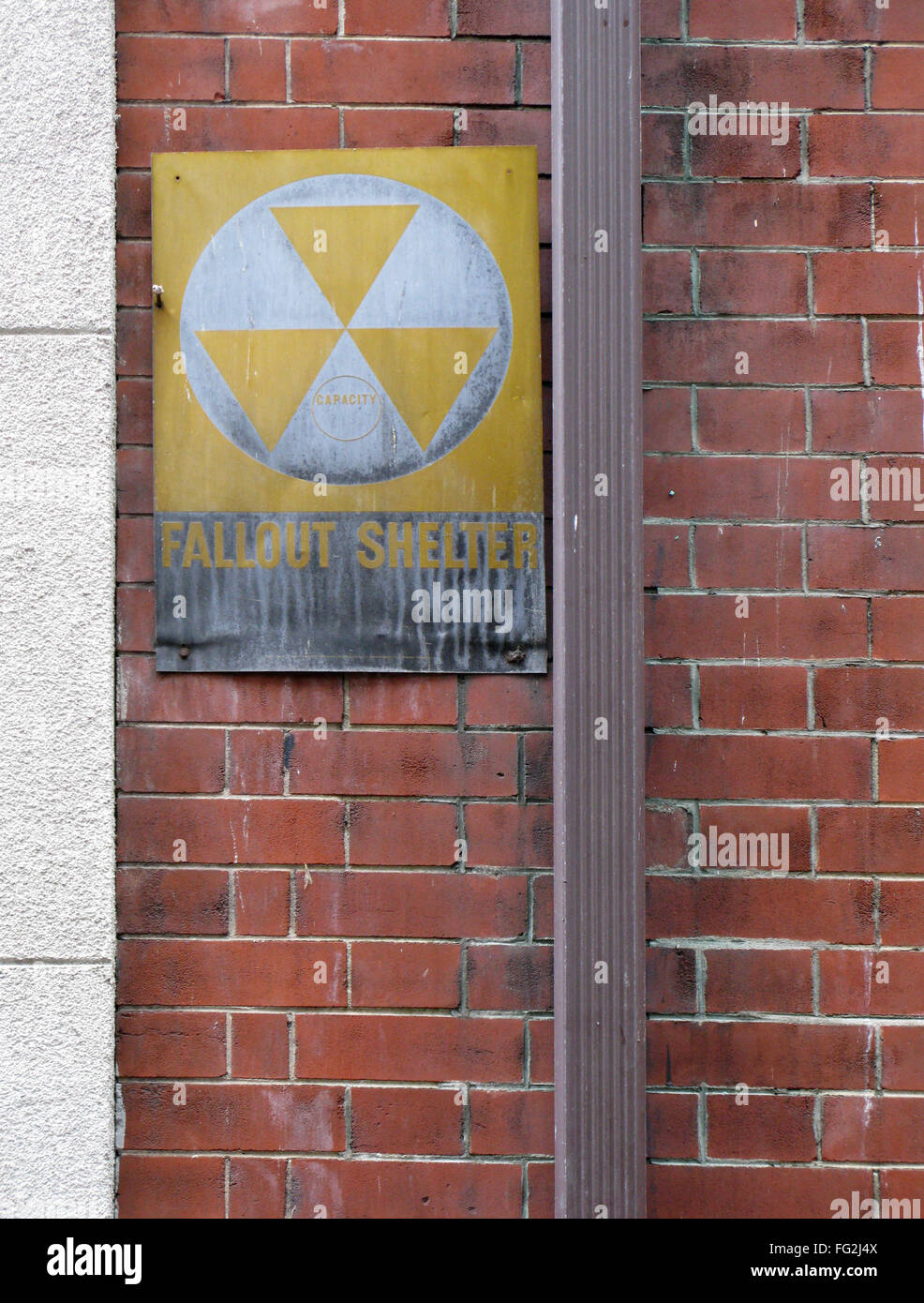 SIGN: FALLOUT SHELTER. /nA sign for a fallout shelter on a building in ...