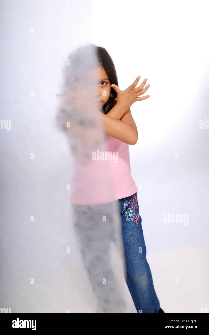 South Asian Indian girl standing in mysterious pose showing hands cross ...