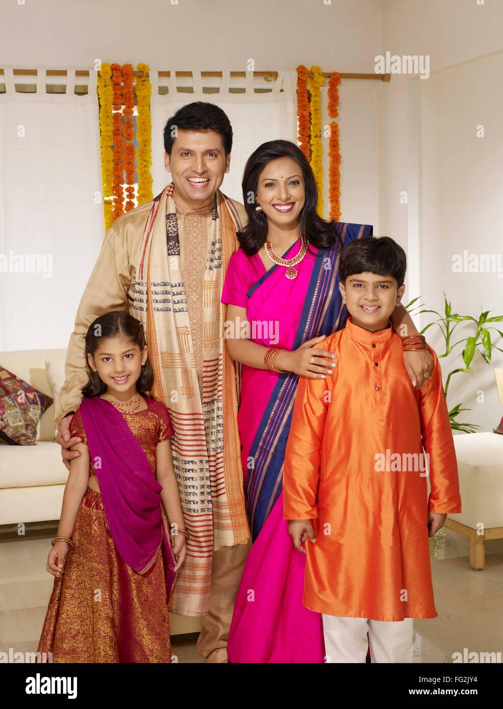Indian family standing wearing traditional hi-res stock photography and ...
