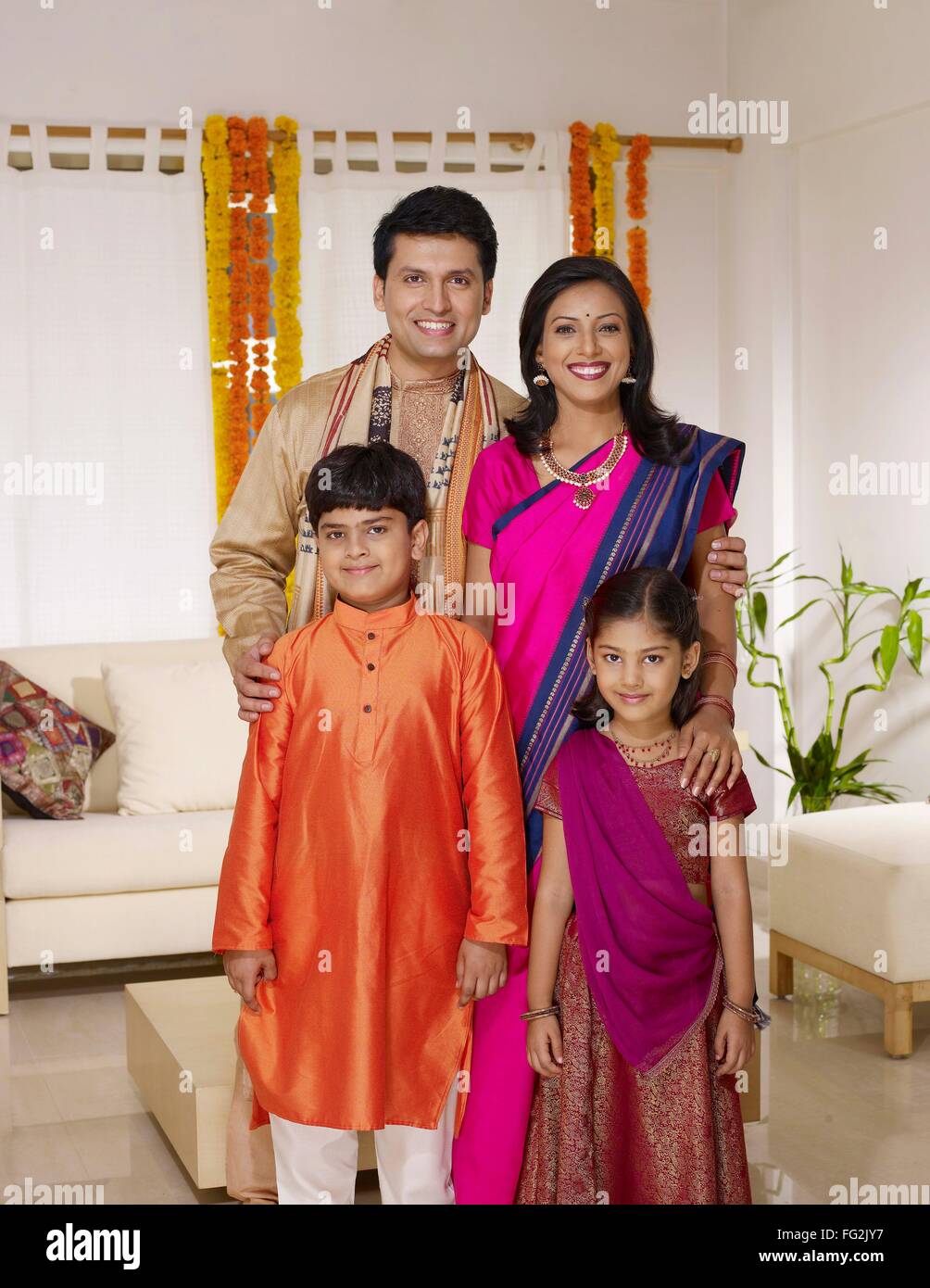 Parents with children in traditional wearing standing in house MR#702R ...