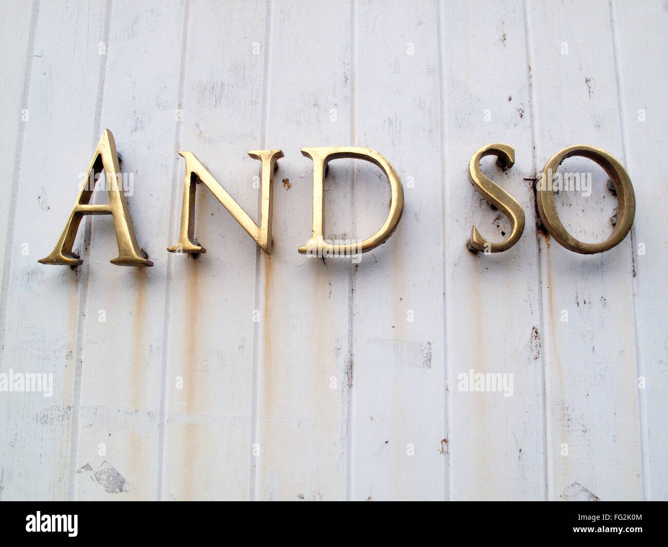 Raised brass letters on a paneled white washed wooden surface Stock ...