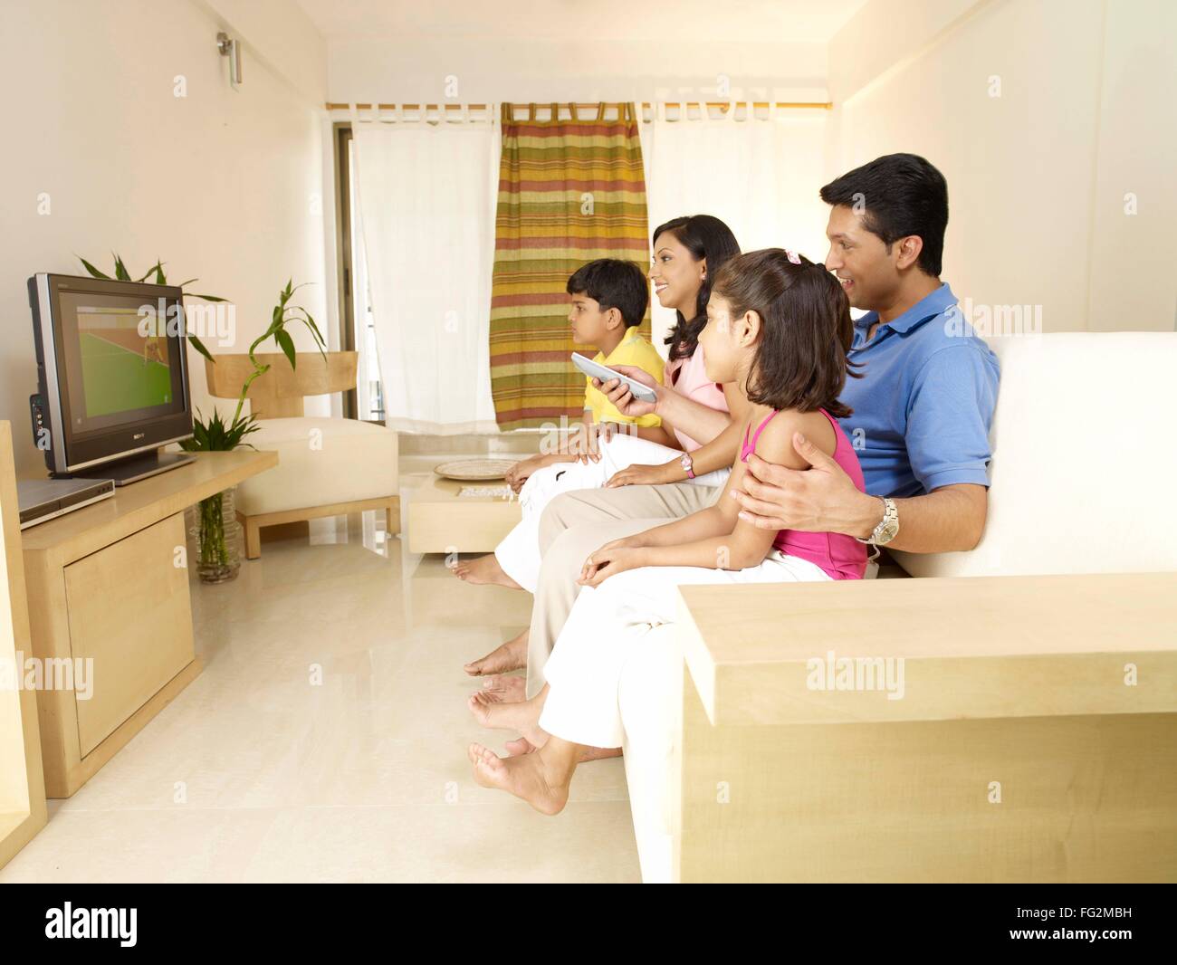 Children with parents watching TV sitting in house MR#702R,MR#702S,MR ...