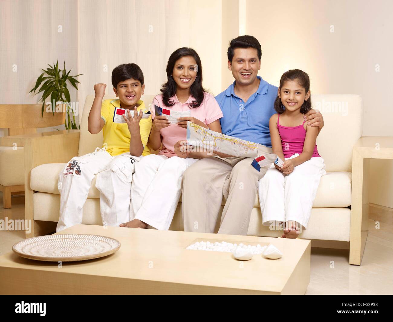 Children with parents looking at booklets and maps sitting in house MR ...