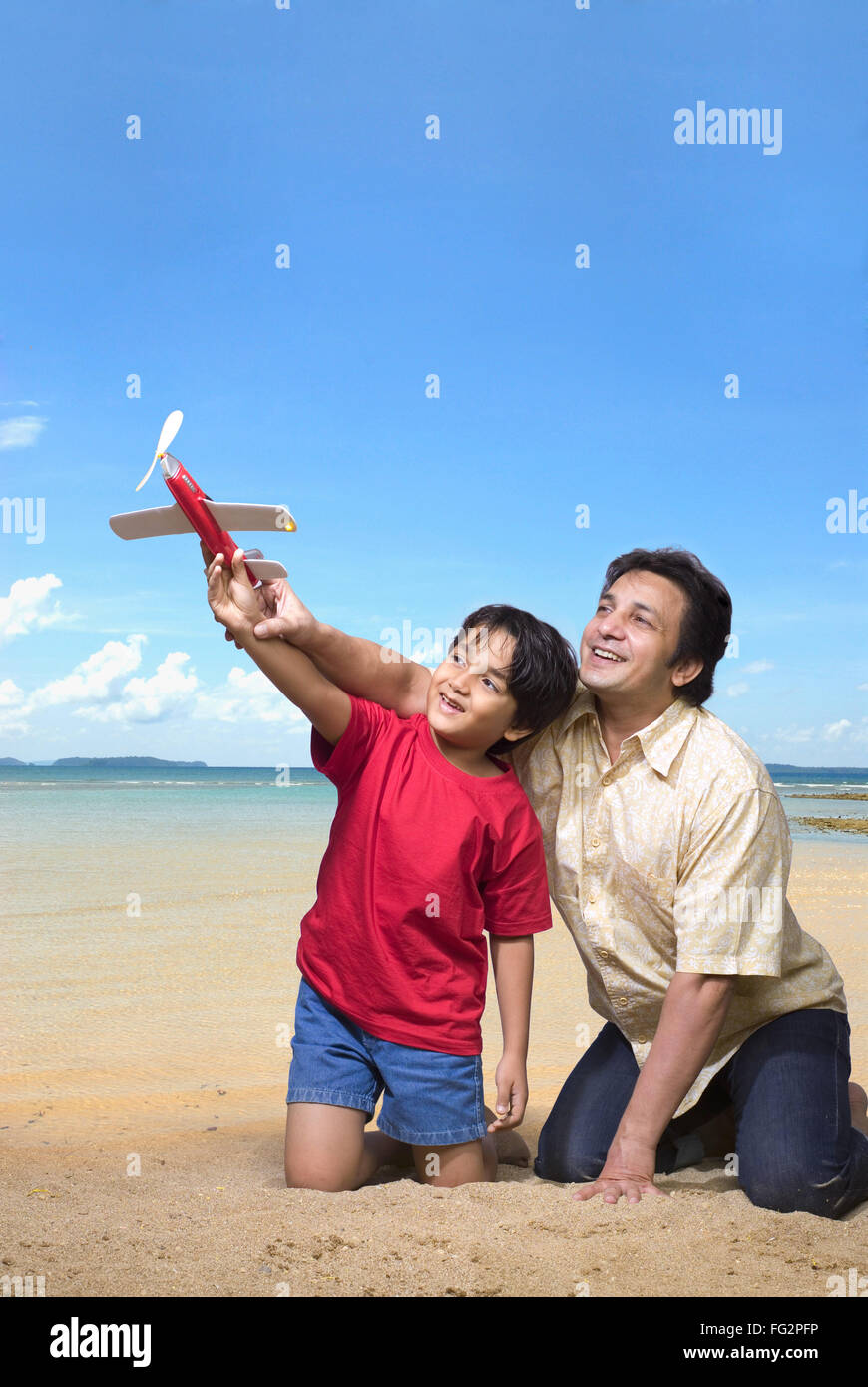 Father showing son flying aeroplane MR#779H;779G Stock Photo - Alamy