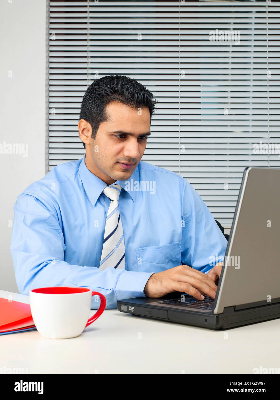 Executive operating laptop MR#779K Stock Photo - Alamy