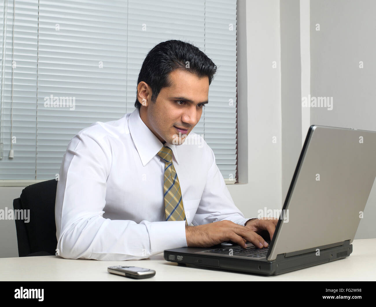 Executive operating laptop MR#779K Stock Photo - Alamy