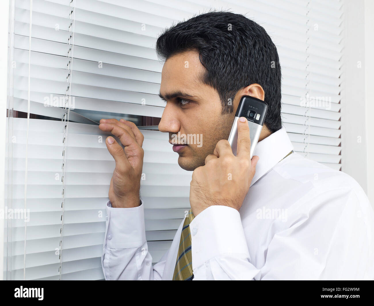 Peeping through blinds hi-res stock photography and images - Alamy