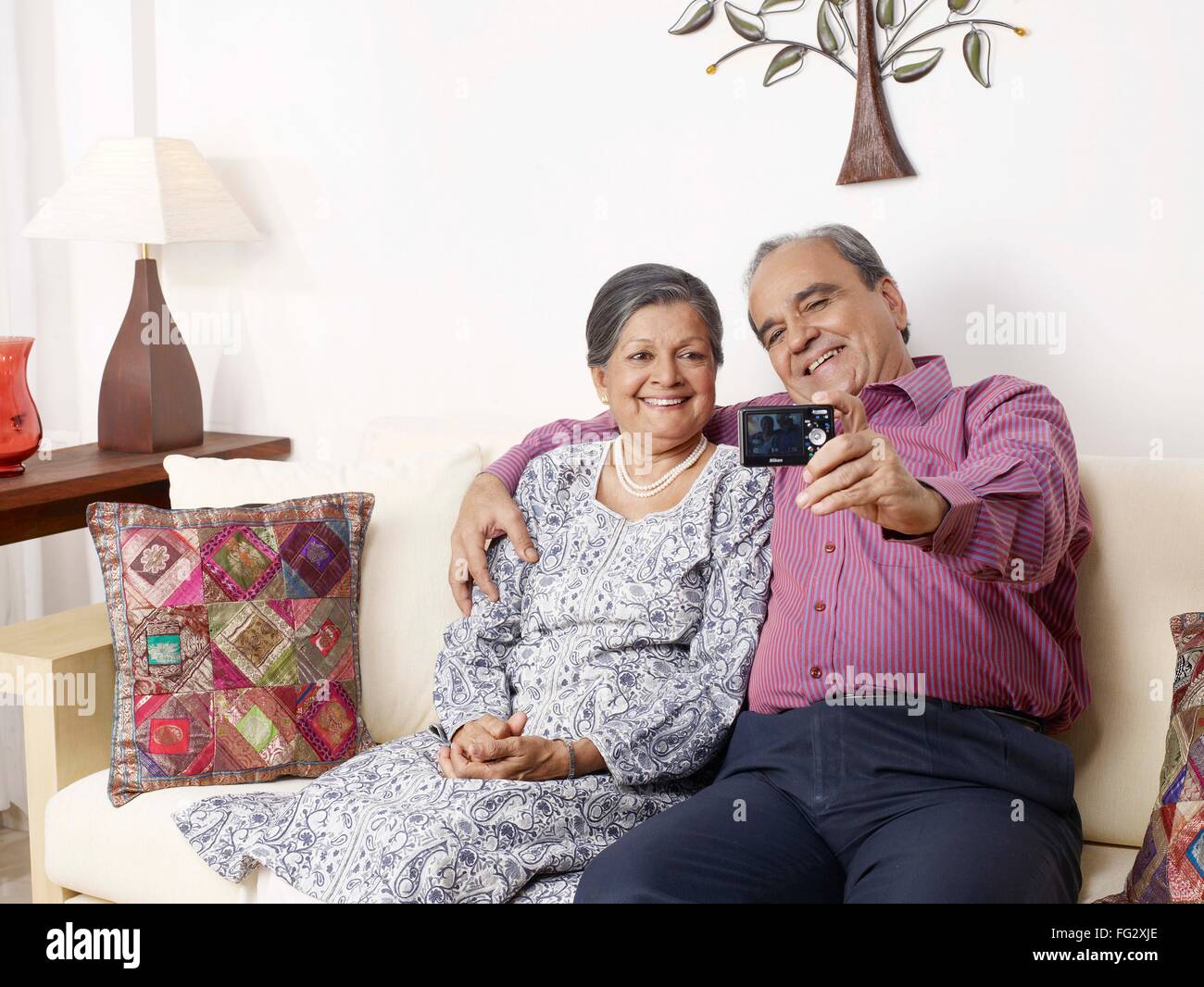 Old Indian senior couple recording moment on digital camera MR#702S&T ...