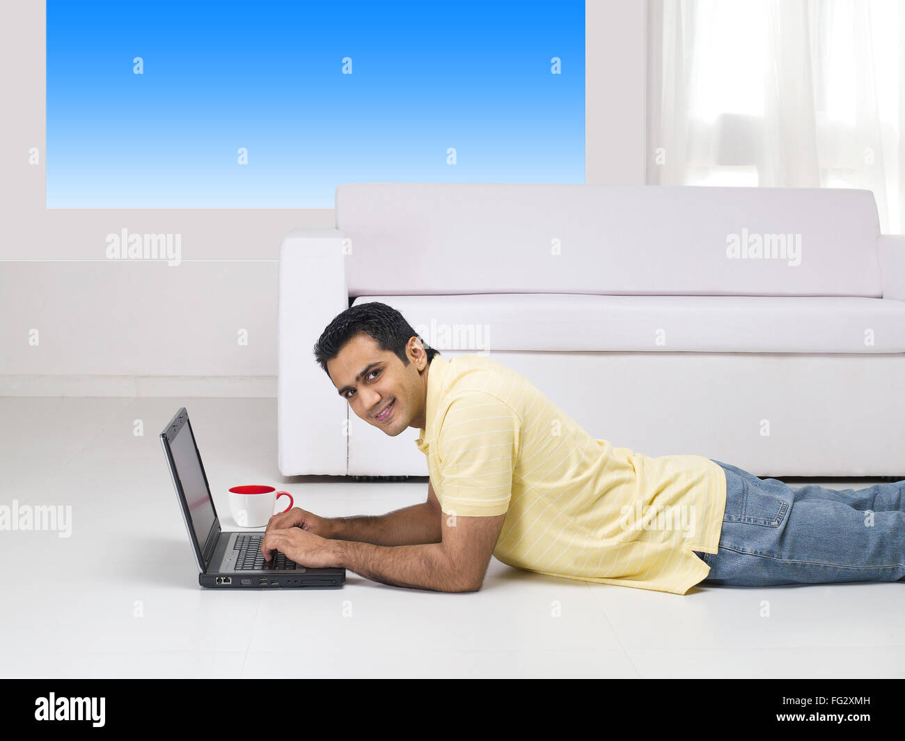 Man laying on floor using laptop MR#779K Stock Photo - Alamy