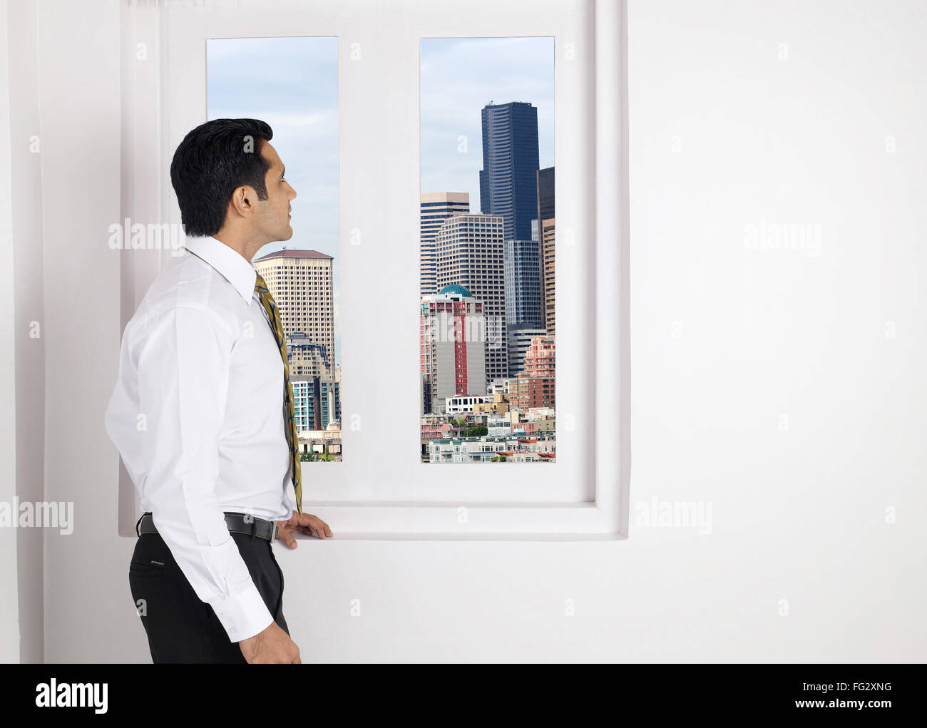 Executive looking skyscraper from window MR#779K Stock Photo - Alamy