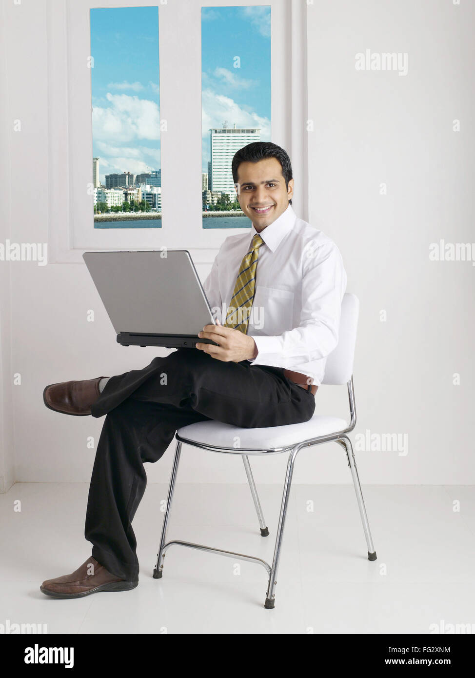 Executive sitting on chair looking at camera MR#779K Stock Photo - Alamy