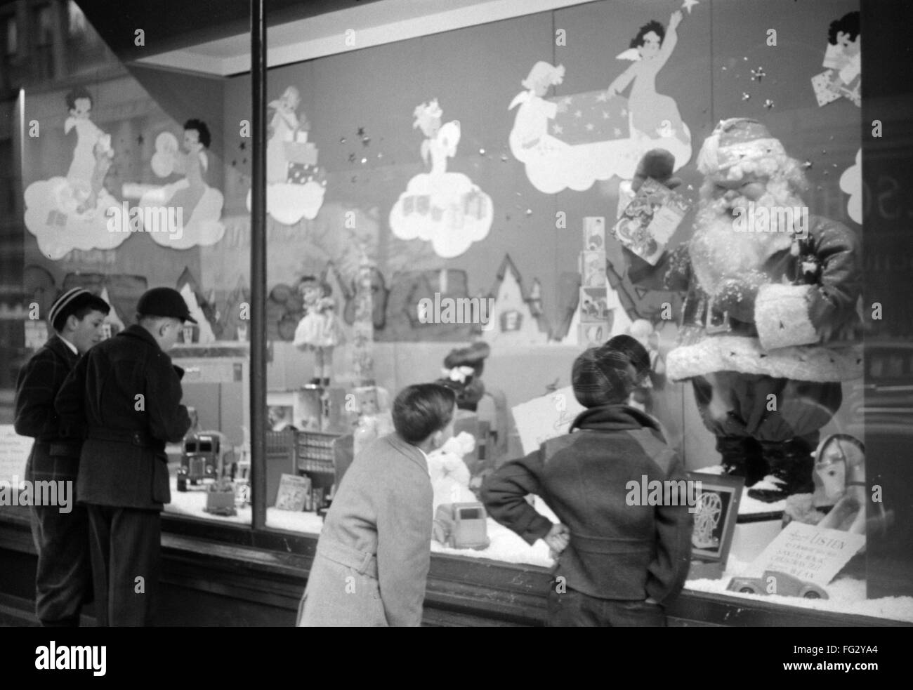 WINDOW SHOPPING, 1940. /nWindow shoppers looking at toys in the window ...