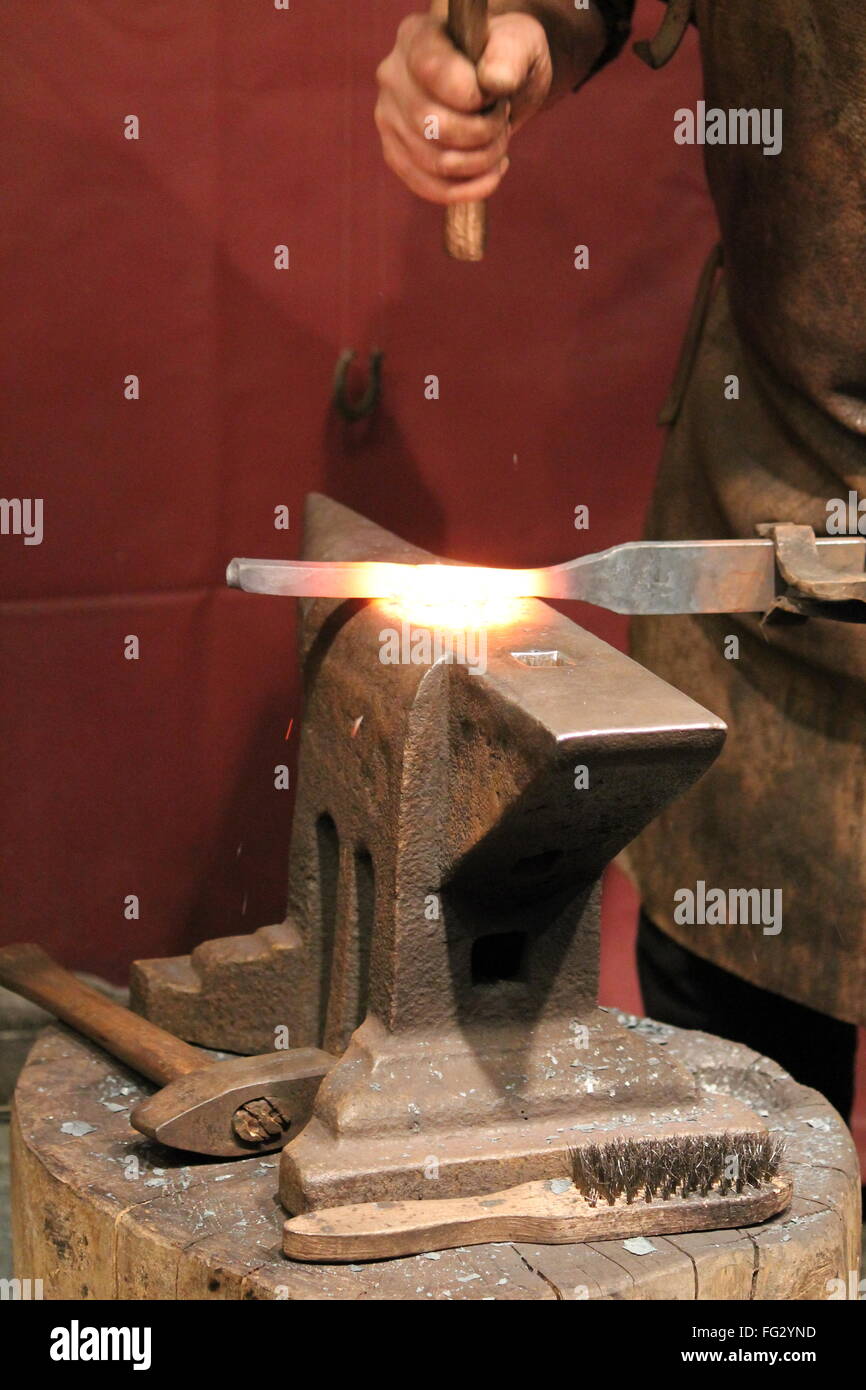 Blacksmith working on metal on anvil at forge high speed detail shot ...
