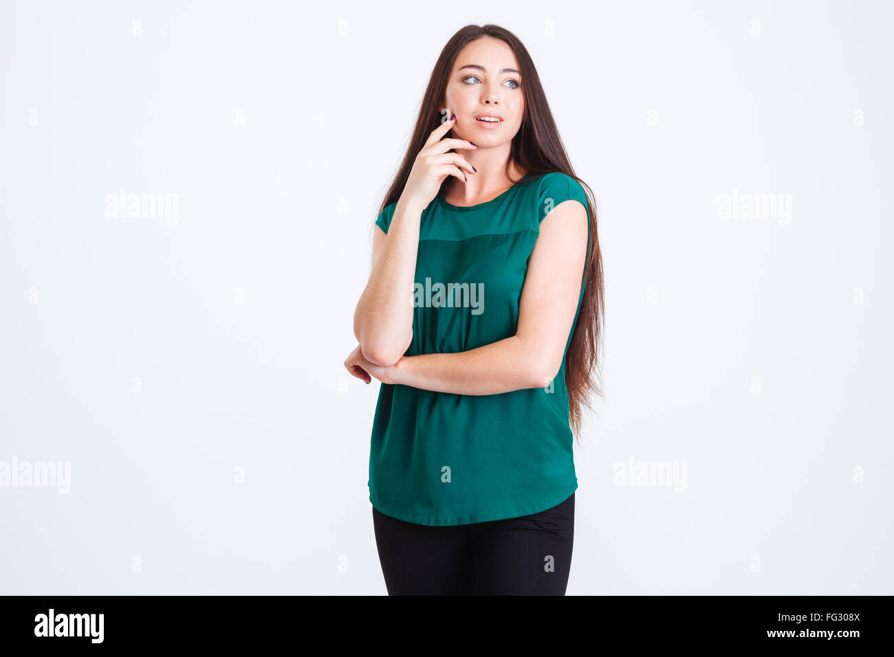 Portrait of thoughtful attractive young woman standing and thinking ...