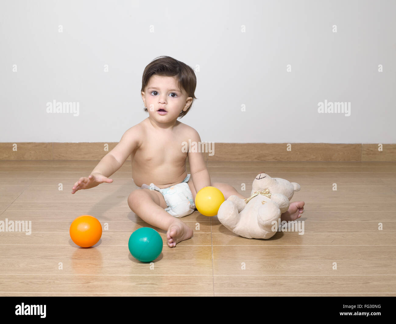 Baby wearing diaper playing with toy hi-res stock photography and ...