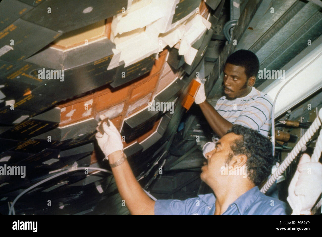 SPACE SHUTTLE, c1981. /nEngineers applying heat shield tiles to the ...