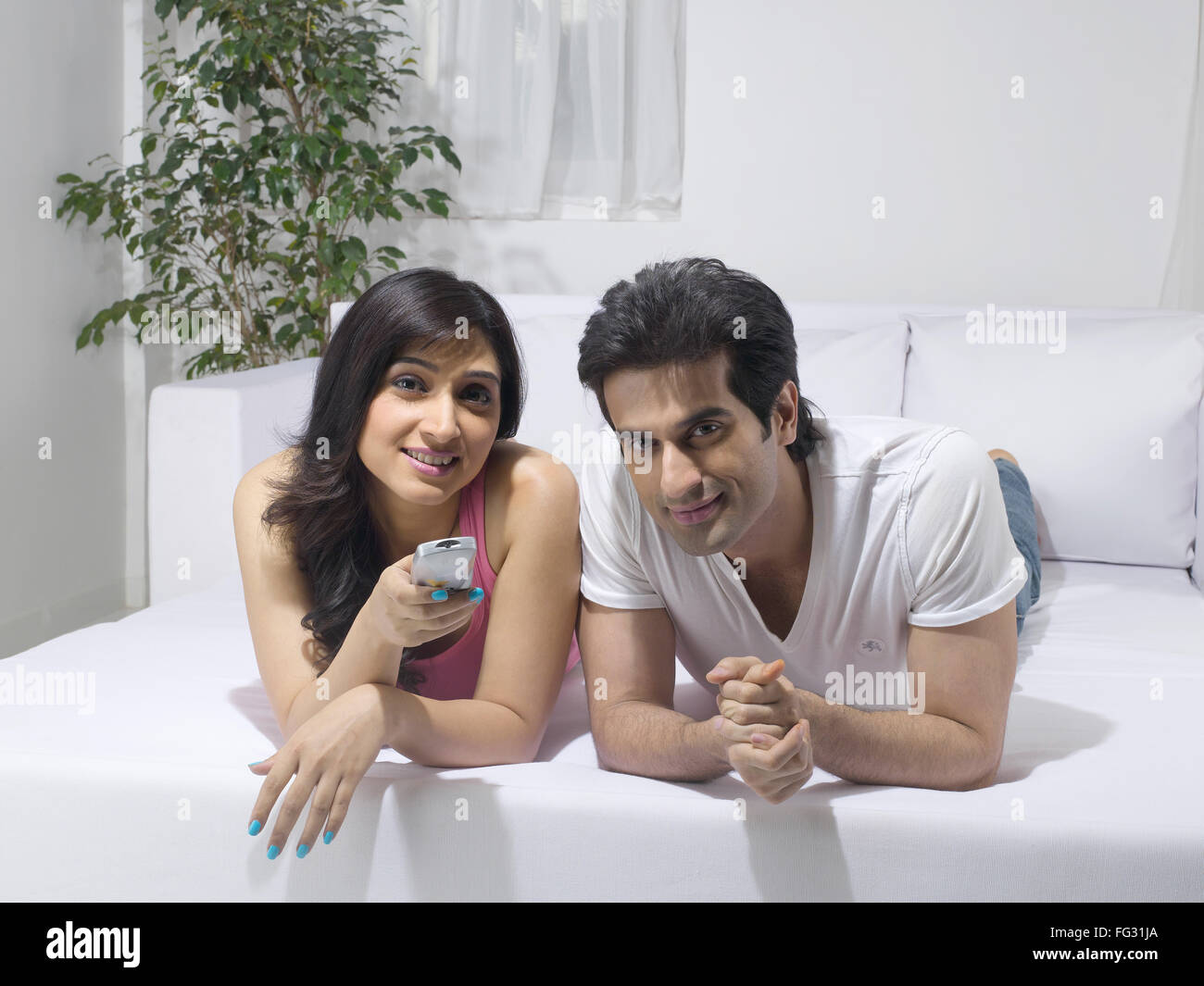 Indian couples remote control hi-res stock photography and images - Alamy