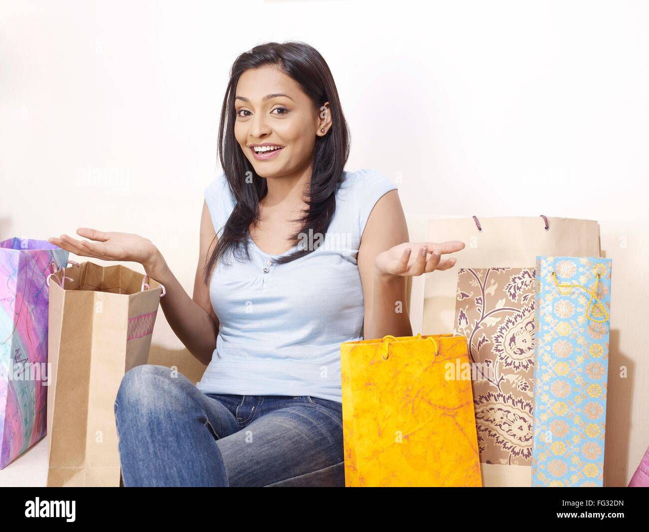 Young lady expressing with hands and colourful shopping bags MR#702U ...
