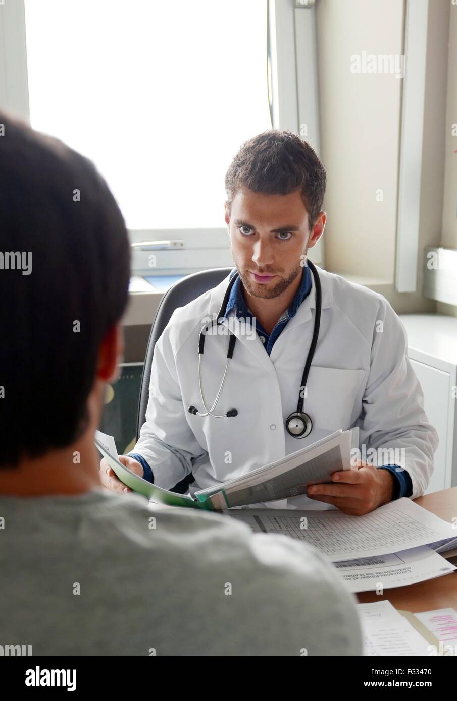 Doctor Consulting Patient At Hospital Stock Photo - Alamy