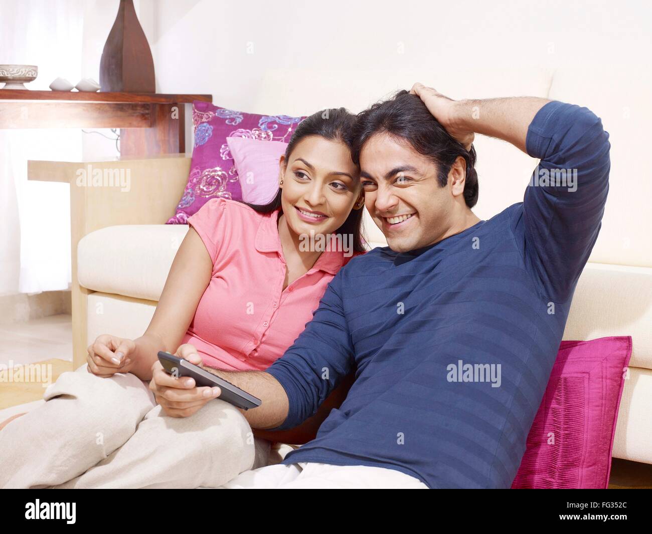 Indian couple home watching tv hi-res stock photography and images - Alamy